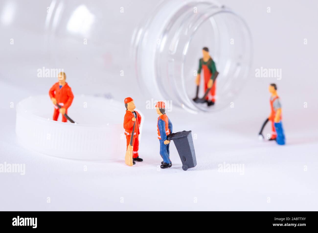 Miniature Workers cleaning and recycling a plastic bottle Stock Photo ...
