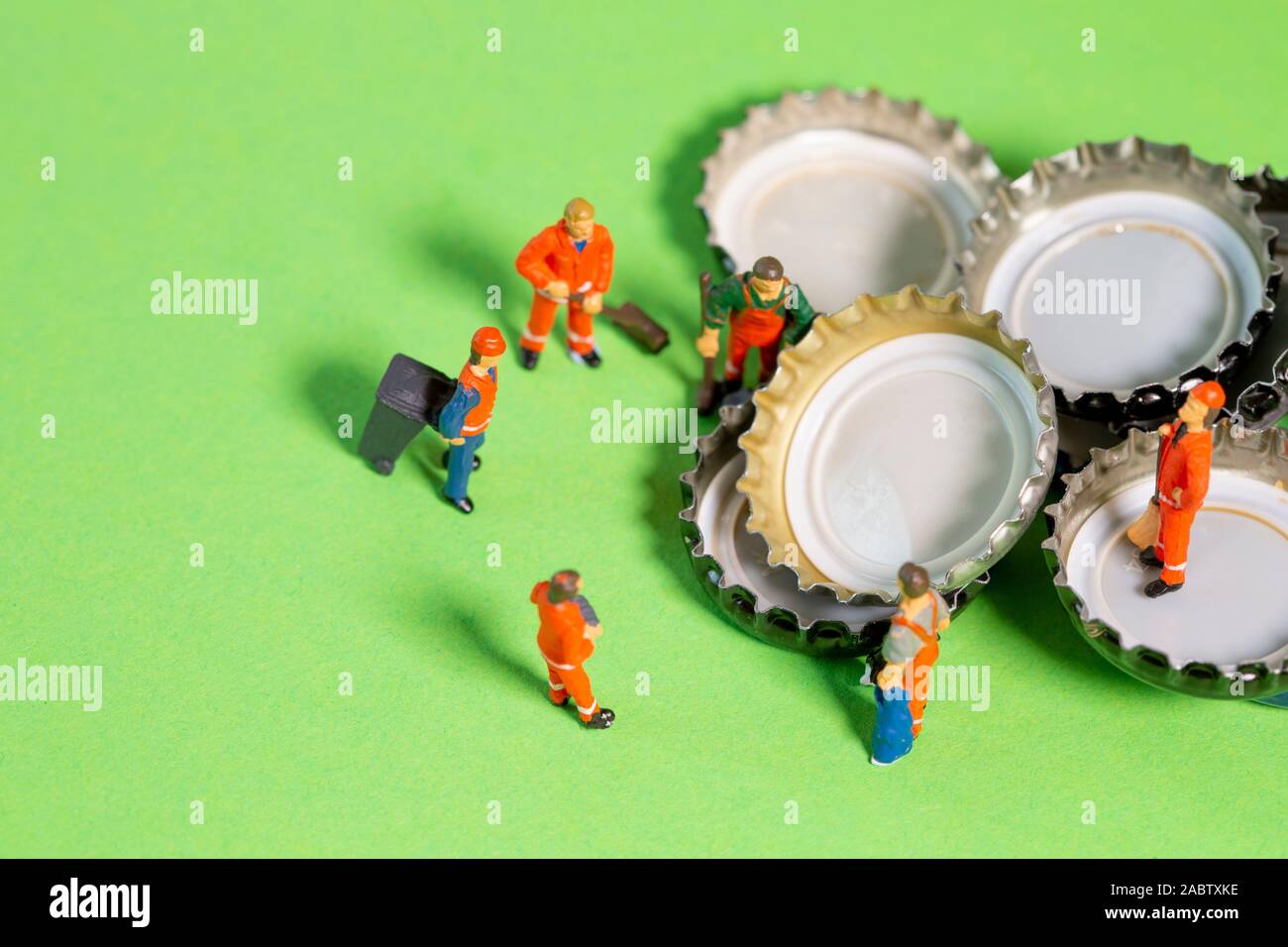 Miniature garbage man recycling aluminium crowns for reuse and to clean ...