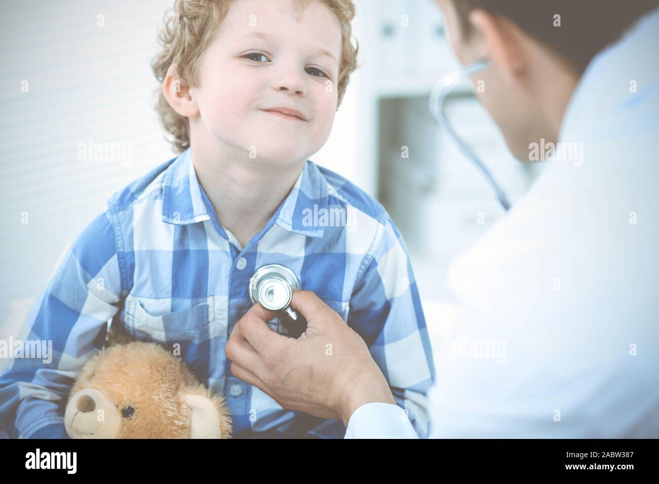 Doctor and patient child. Physician examining little boy. Regular ...