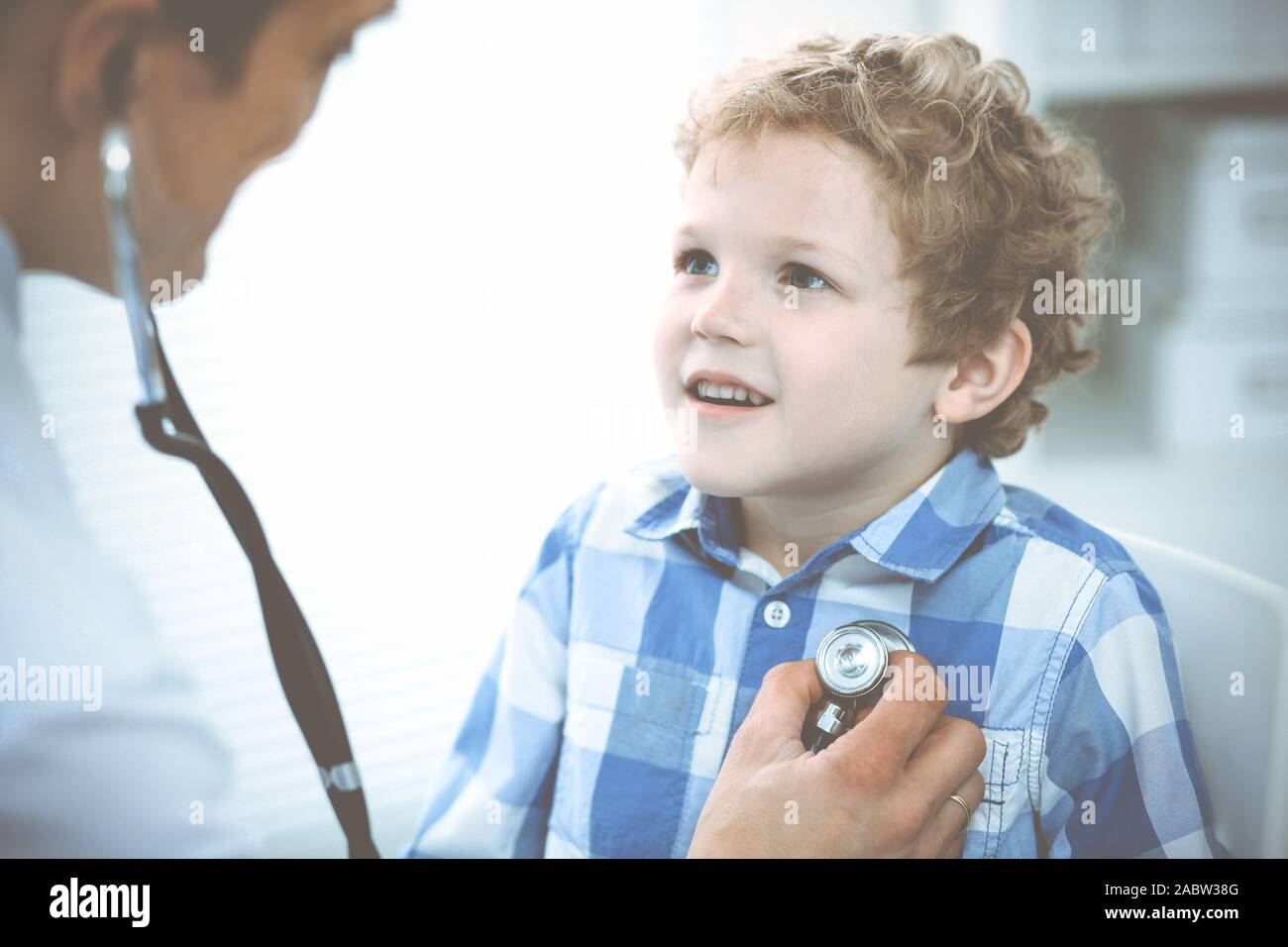 Doctor and patient child. Physician examining little boy. Regular ...