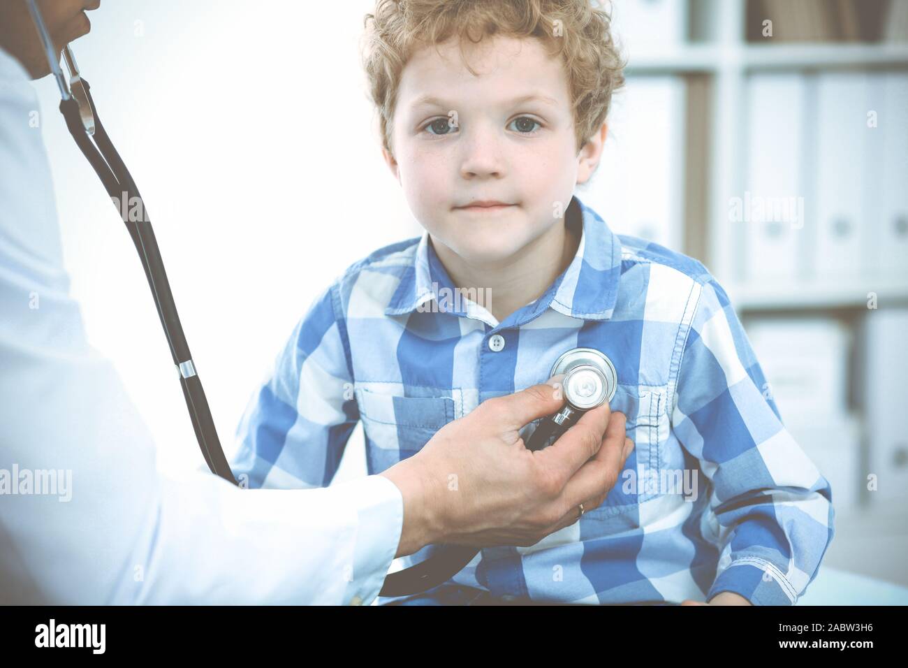 Doctor and patient child. Physician examining little boy. Regular ...
