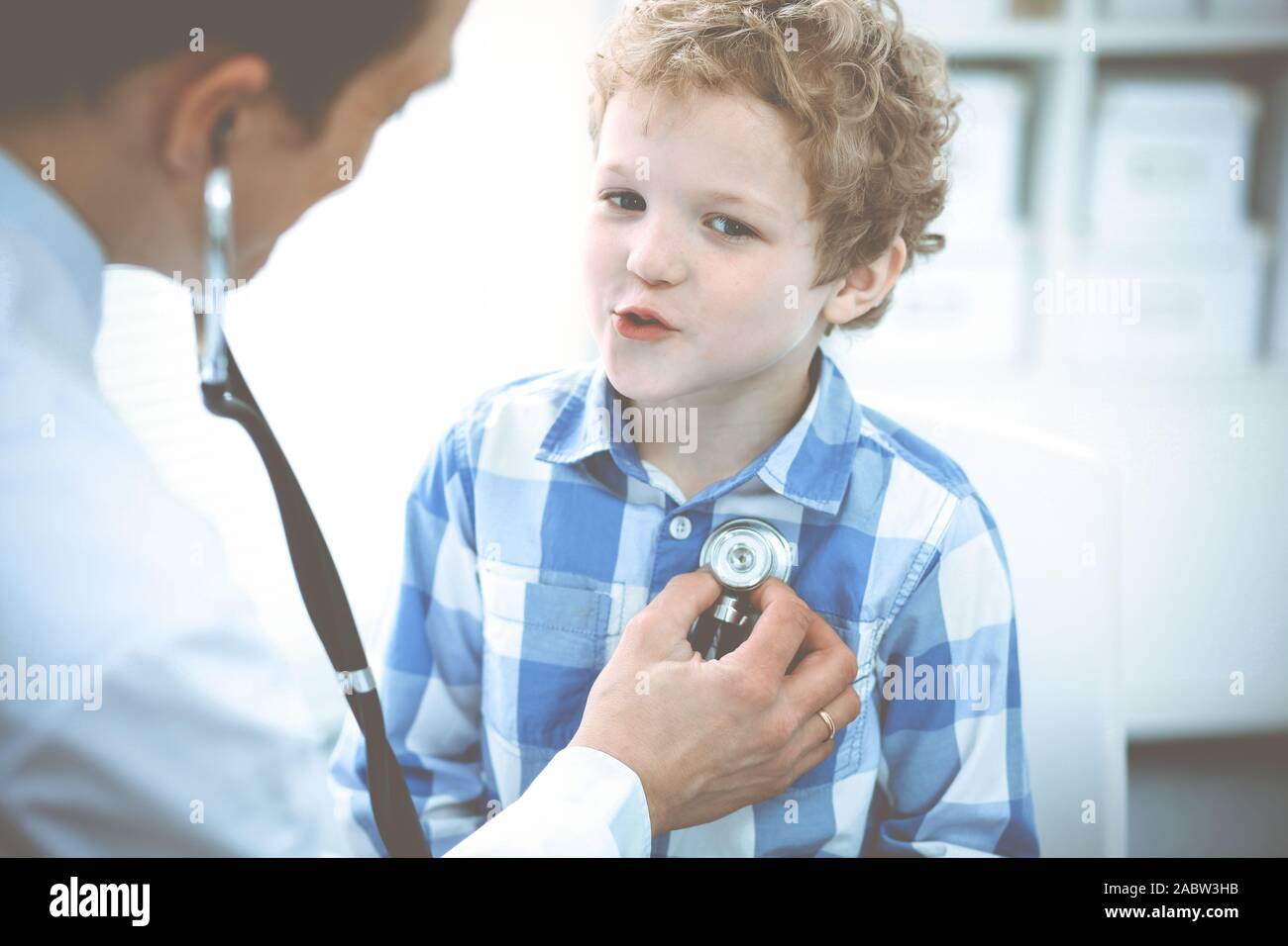 Doctor and patient child. Physician examining little boy. Regular ...