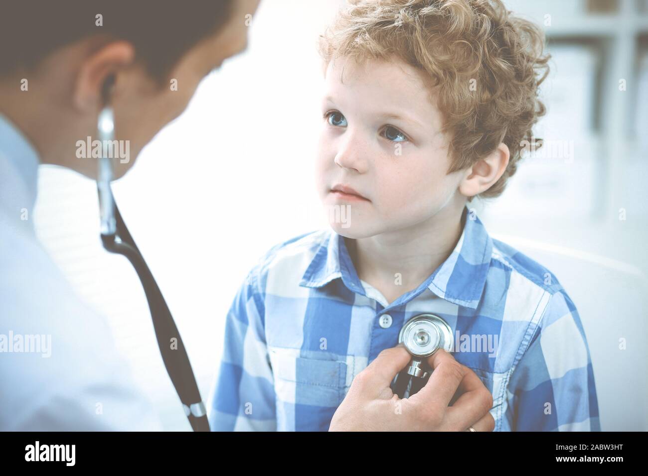 Doctor and patient child. Physician examining little boy. Regular ...