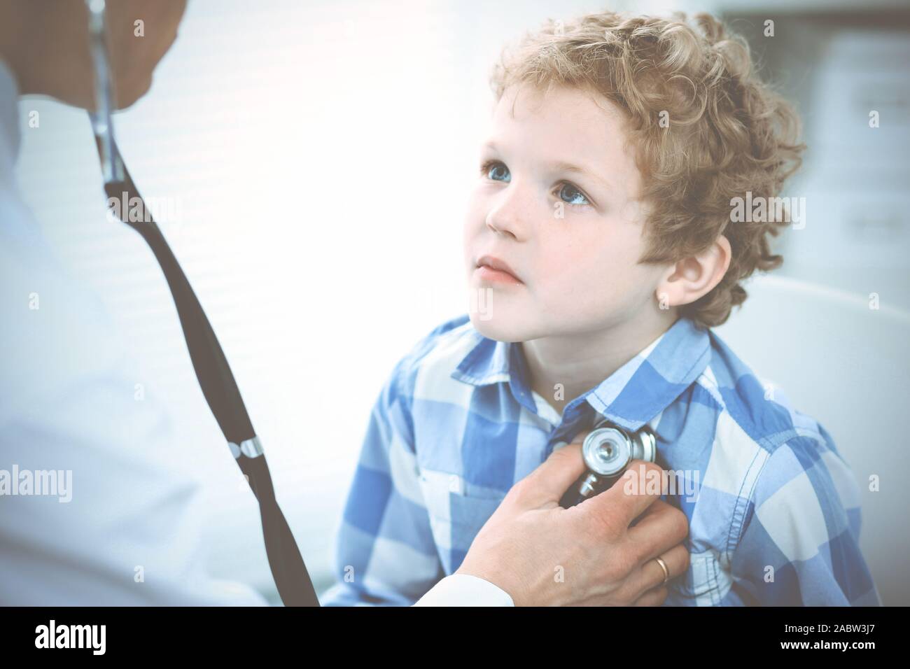 Doctor and patient child. Physician examining little boy. Regular ...