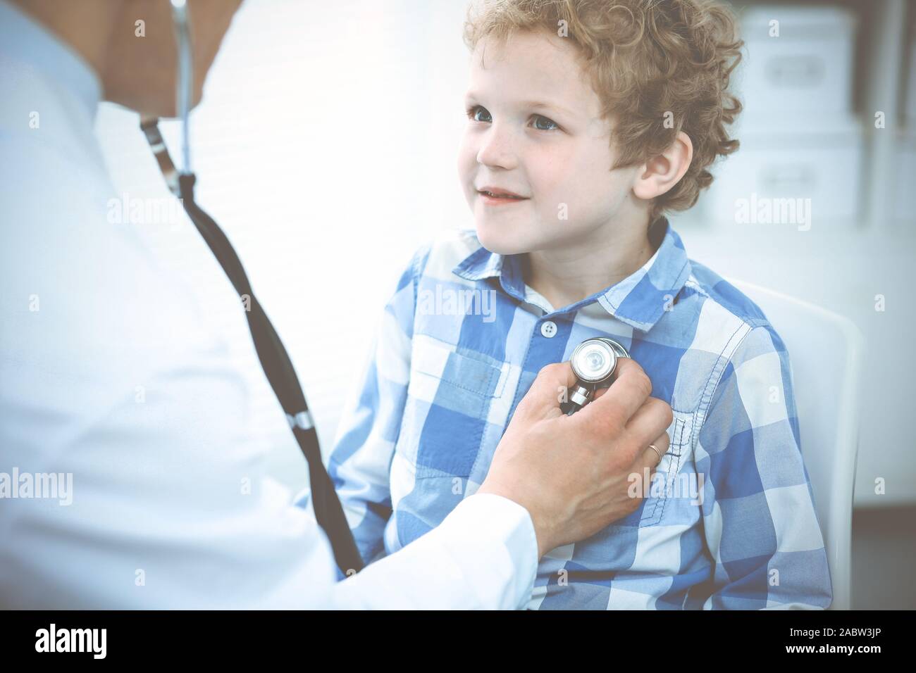 Doctor and patient child. Physician examining little boy. Regular ...