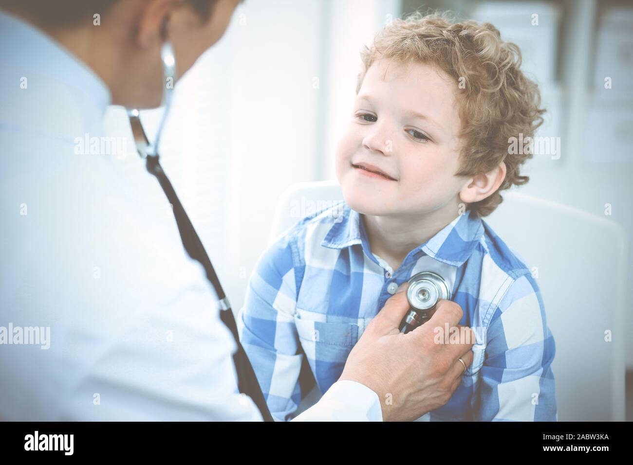 Doctor and patient child. Physician examining little boy. Regular ...