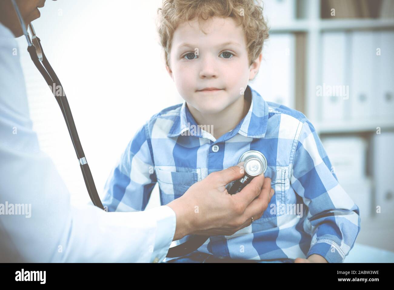 Doctor and patient child. Physician examining little boy. Regular ...