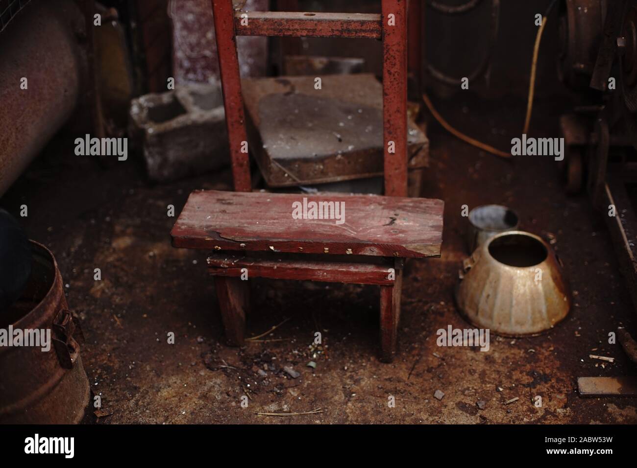 homemade chair and household items on a dirty floor Stock Photo - Alamy