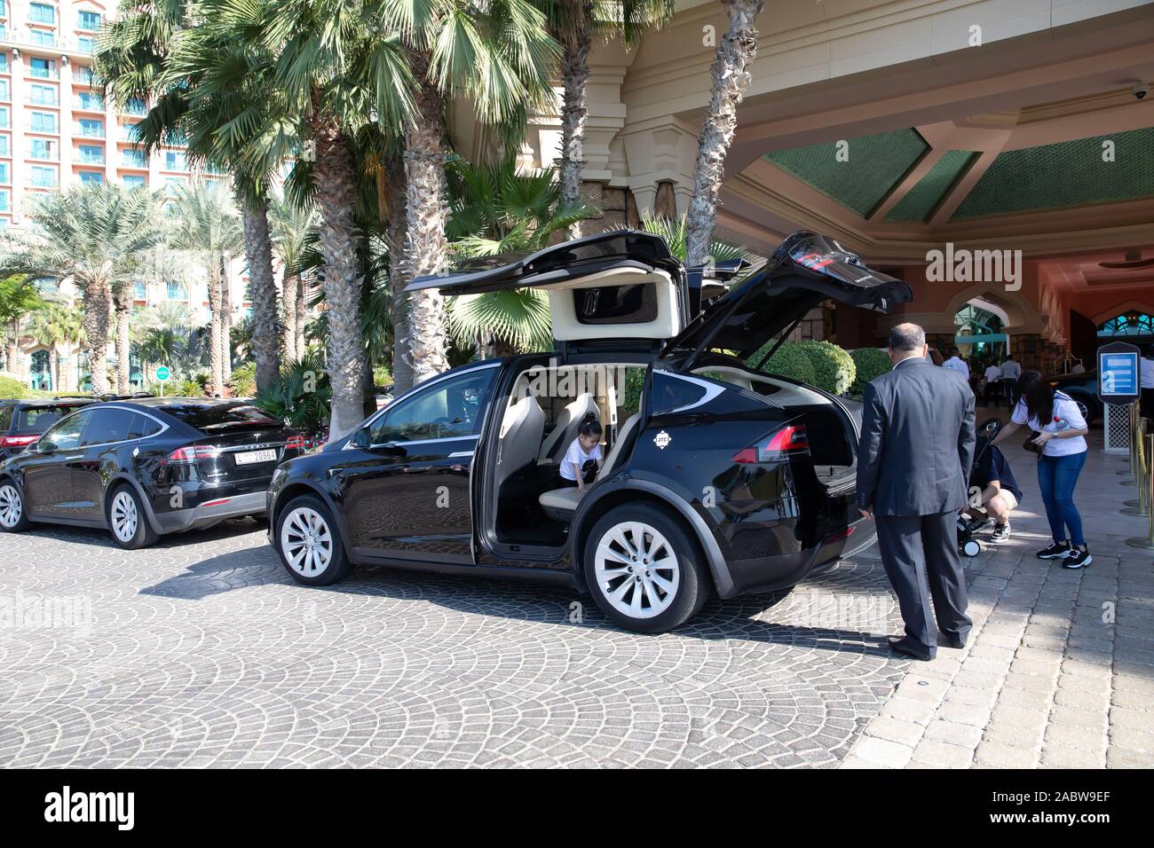 Tesla car parked outside the Atlantis Hotel, on the palm in Dubai Stock ...