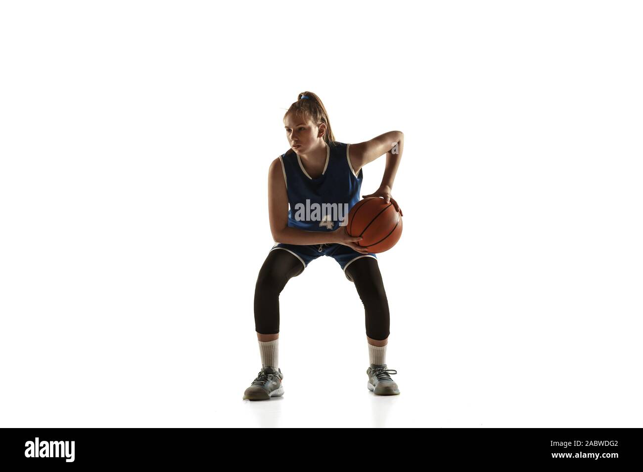 Young caucasian female basketball player of team in action, motion in ...