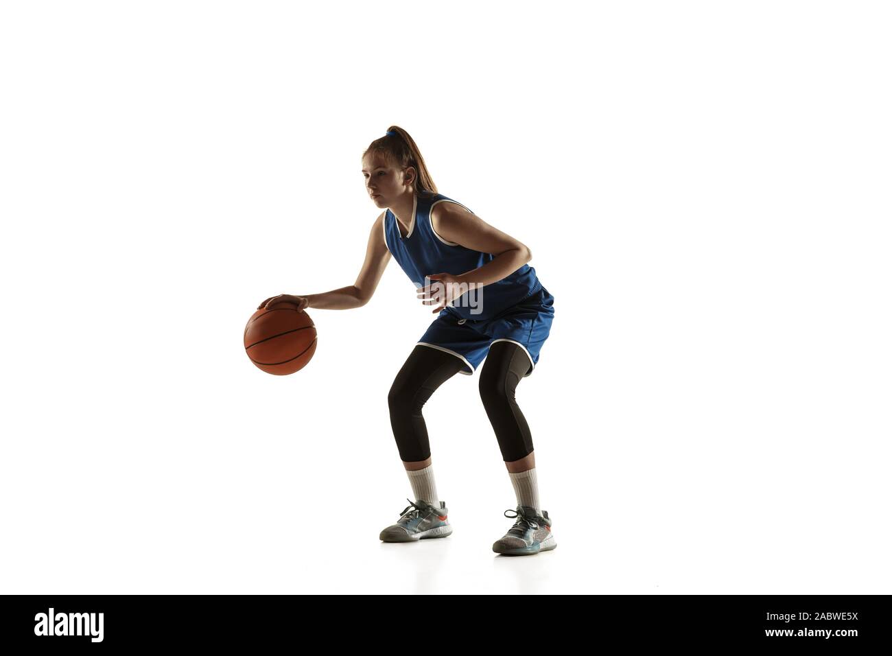 Young caucasian female basketball player of team in action, motion in ...