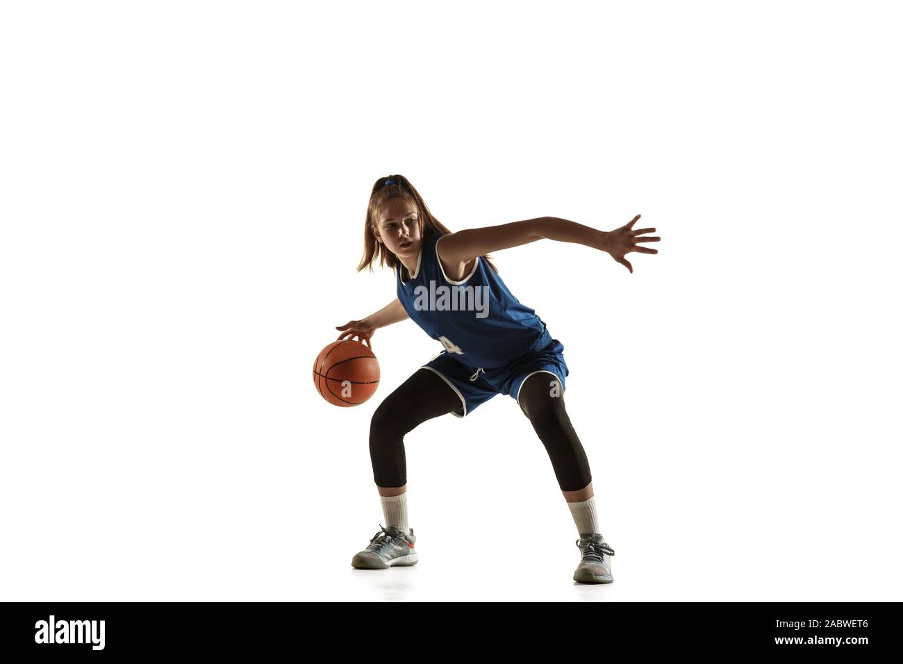 Young caucasian female basketball player of team in action, motion in ...