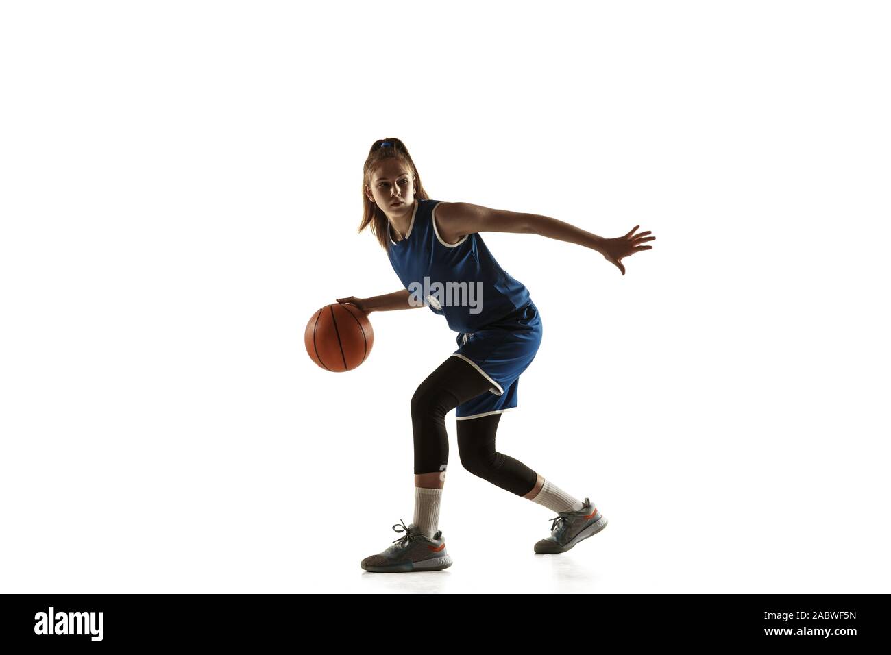 Young caucasian female basketball player of team in action, motion in ...