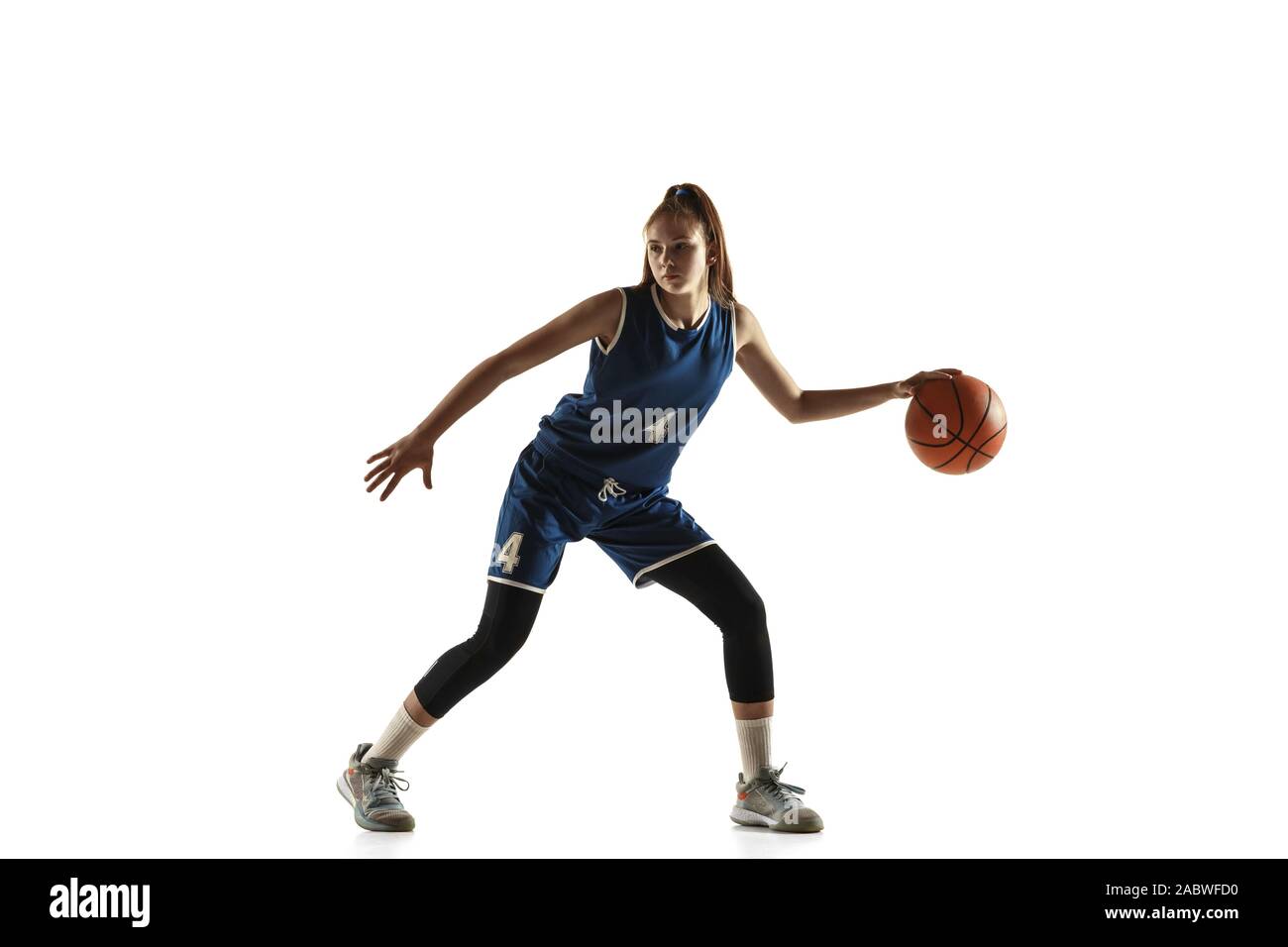 Young caucasian female basketball player of team in action, motion in ...