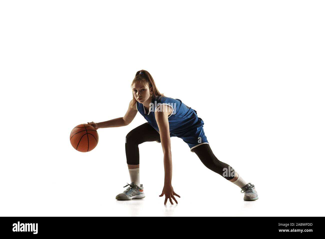 Young caucasian female basketball player of team in action, motion in ...