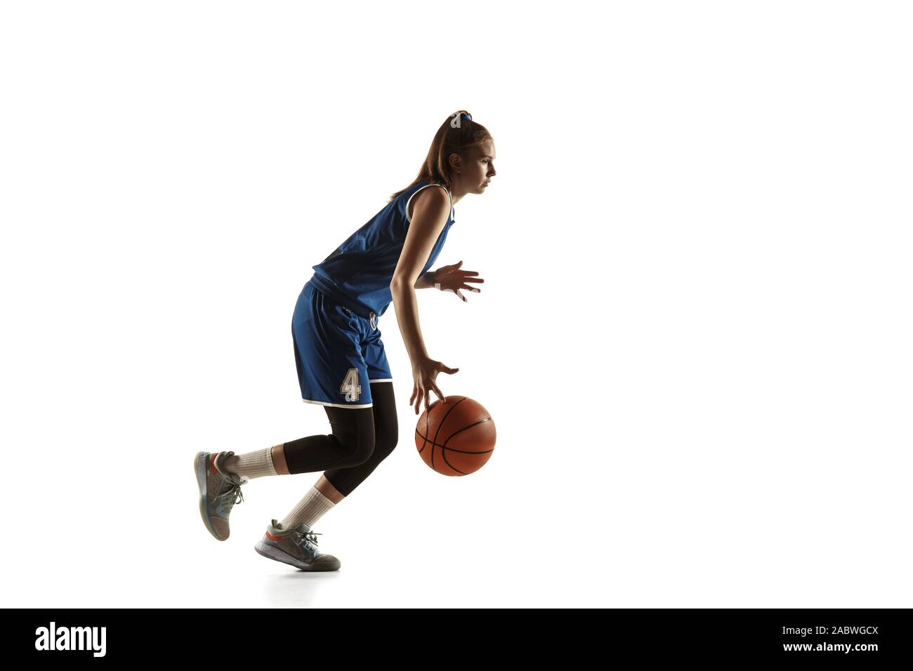 Young caucasian female basketball player of team in action, motion in ...