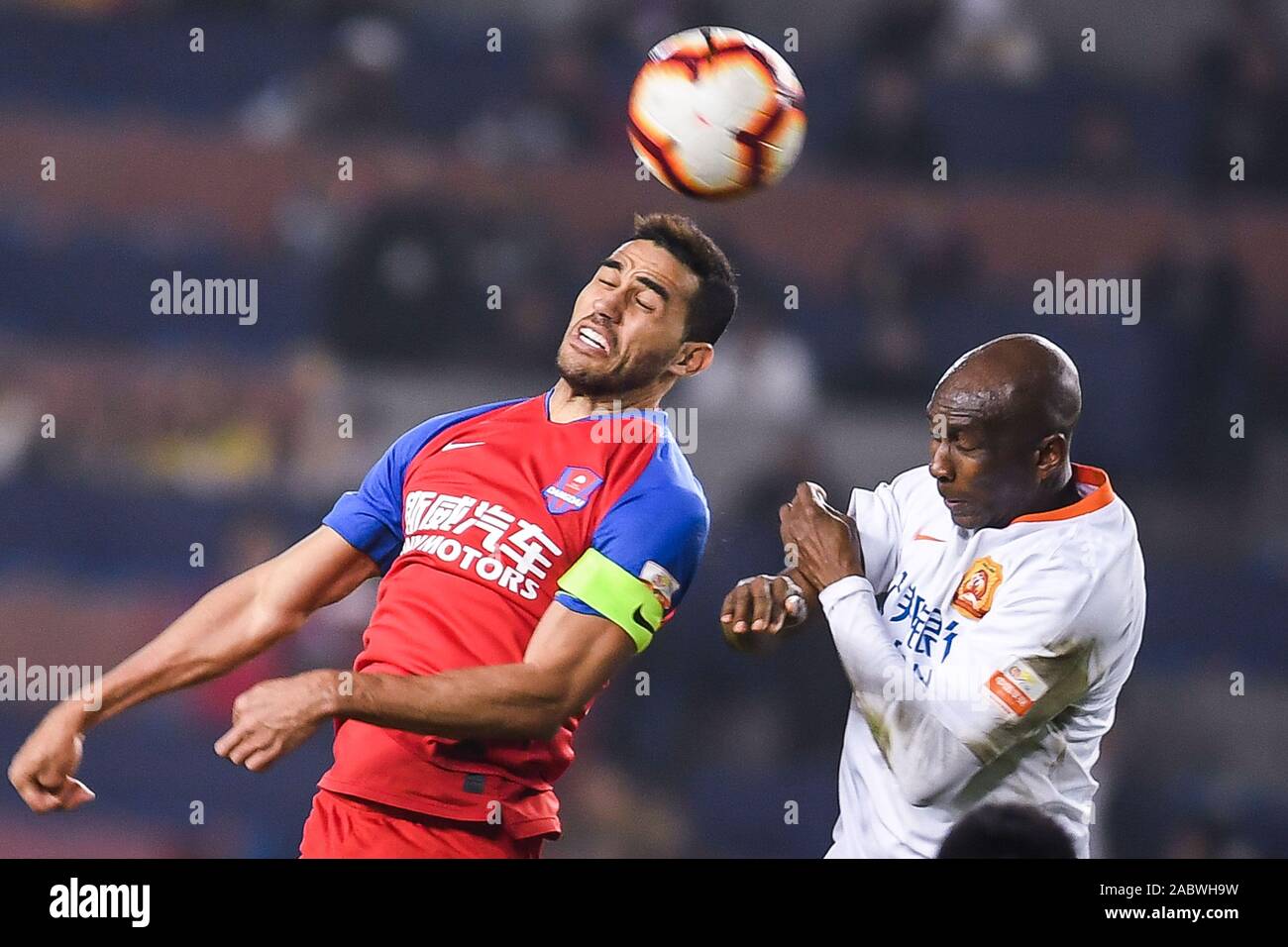 Brazilian football player Alan Kardec of Chongqing SWM, left, struggles ...