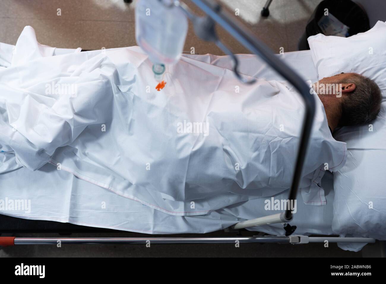 senior man plus year old man recovering from surgery in a hospital bed ...