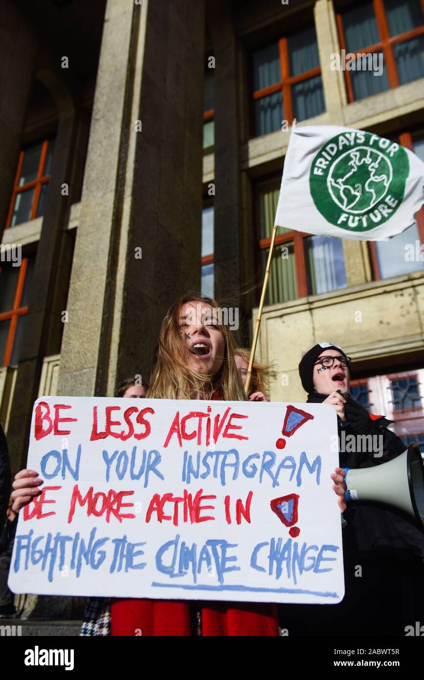 A student chants slogans while holding a placard during the global ...