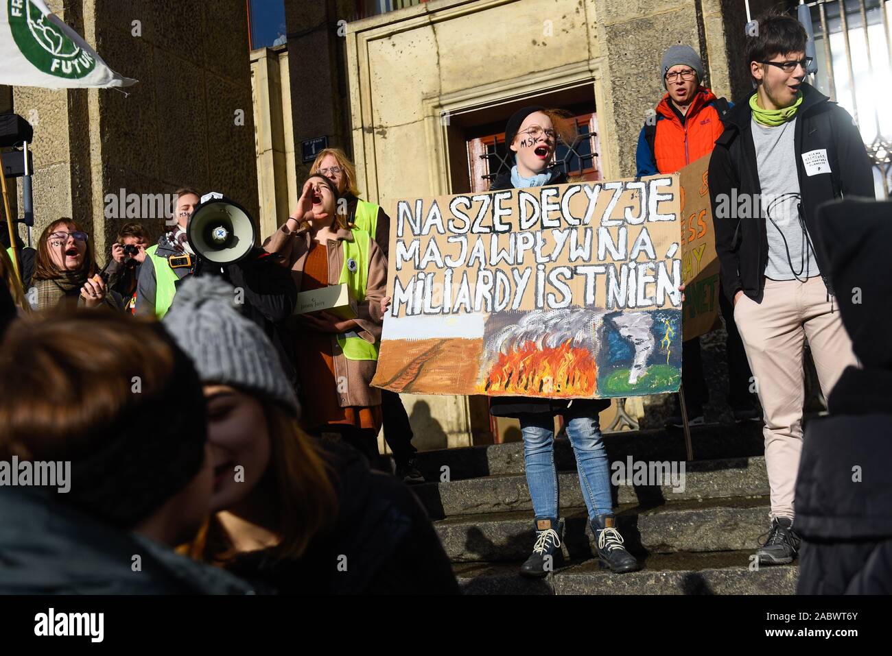 A student chants slogans while holding a placard during the global ...