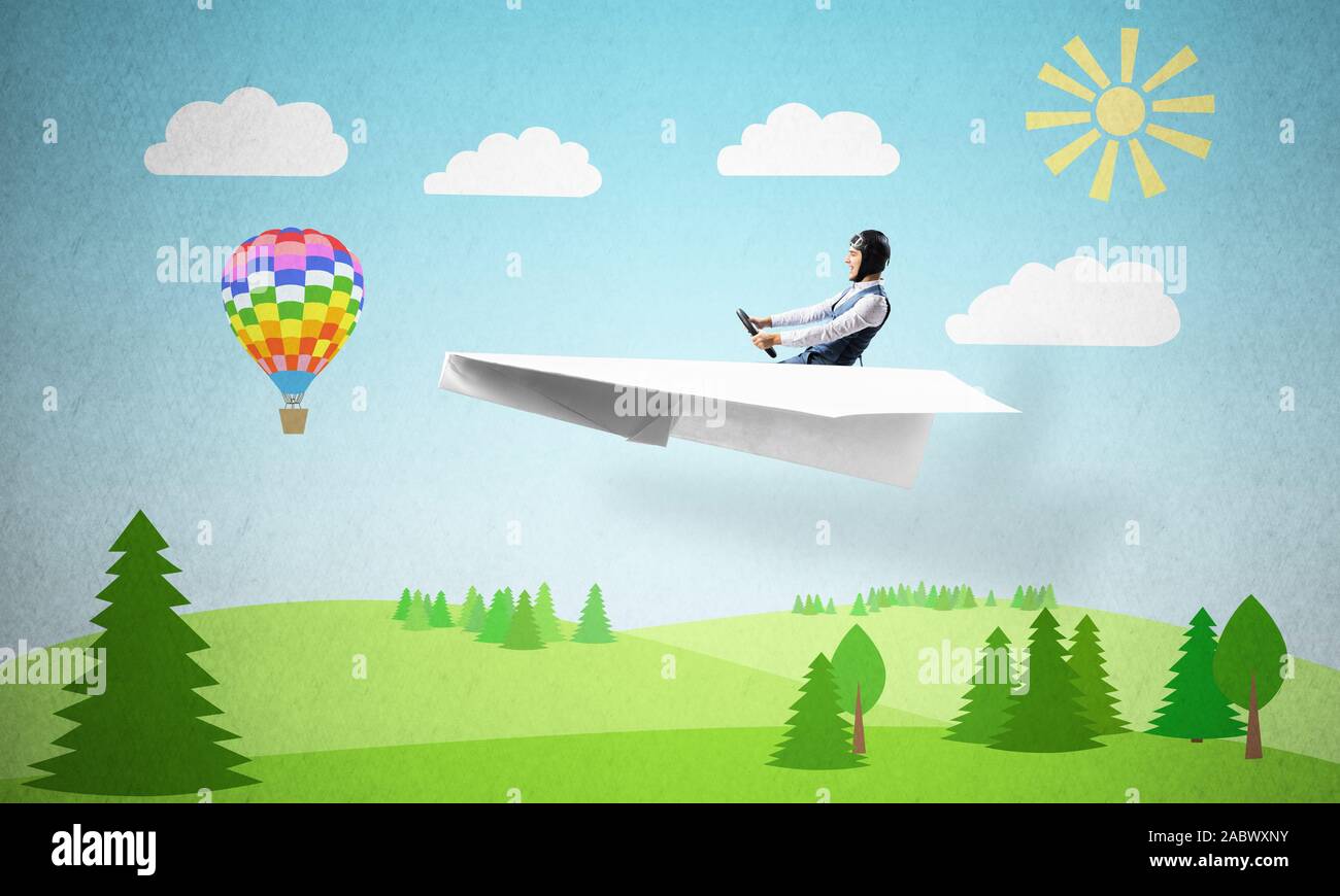 Aviator driving paper plane on nature landscape Stock Photo - Alamy