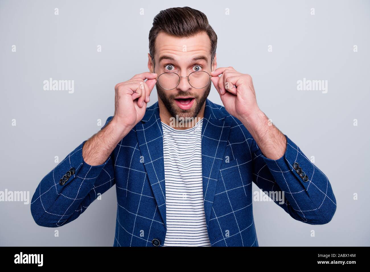 Photo of excited smart man looking at you wearing specs observing his ...