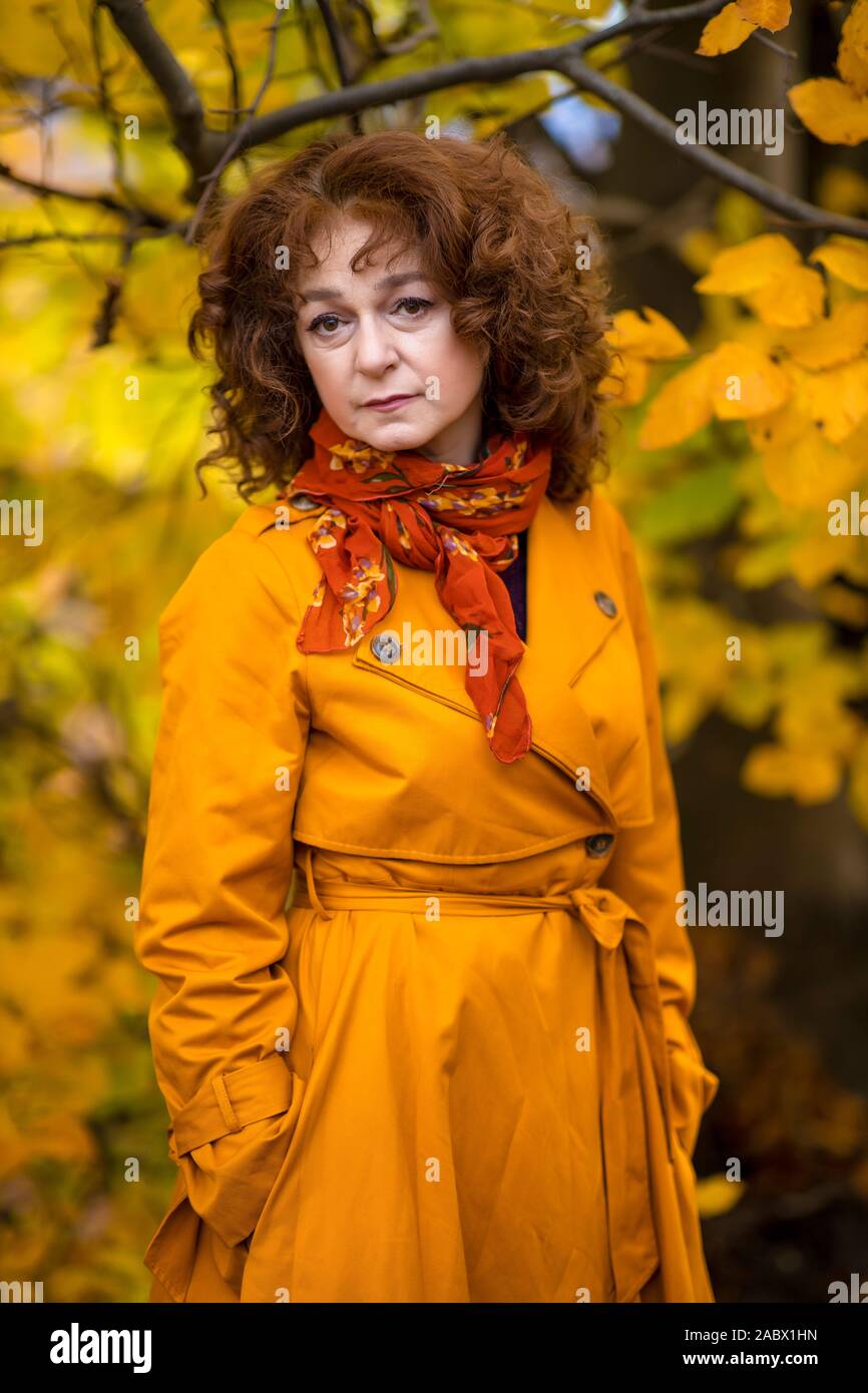 Seasonal portrait of a mature woman outdoor in vibrant forest Stock ...