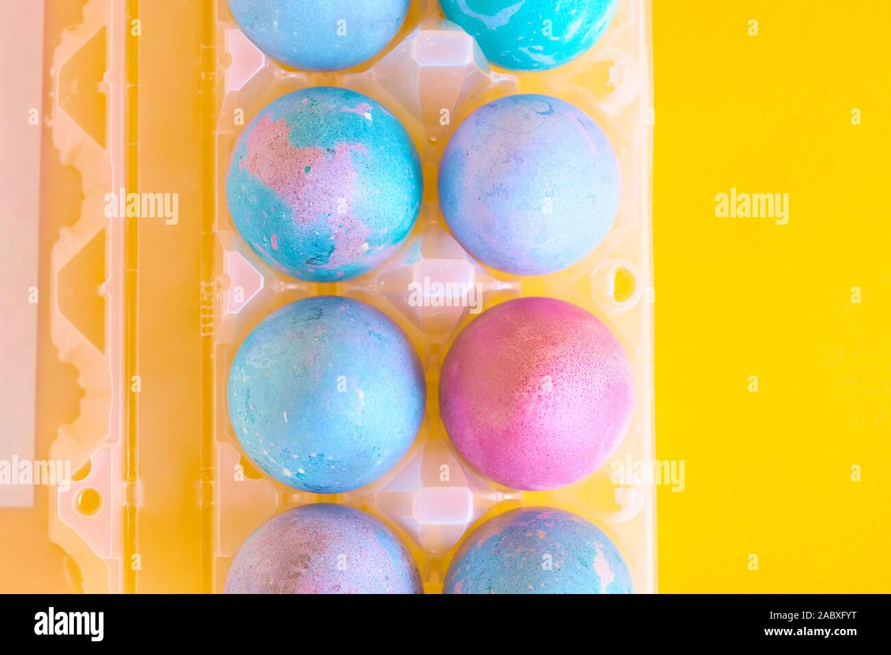 Painted Easter eggs with space intergalactic pattern in stand on yellow ...