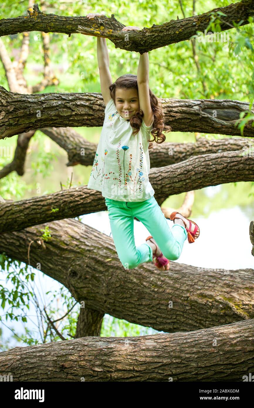 Happy Little Girl on tree trunk. Childhood, Summer forest Stock Photo ...