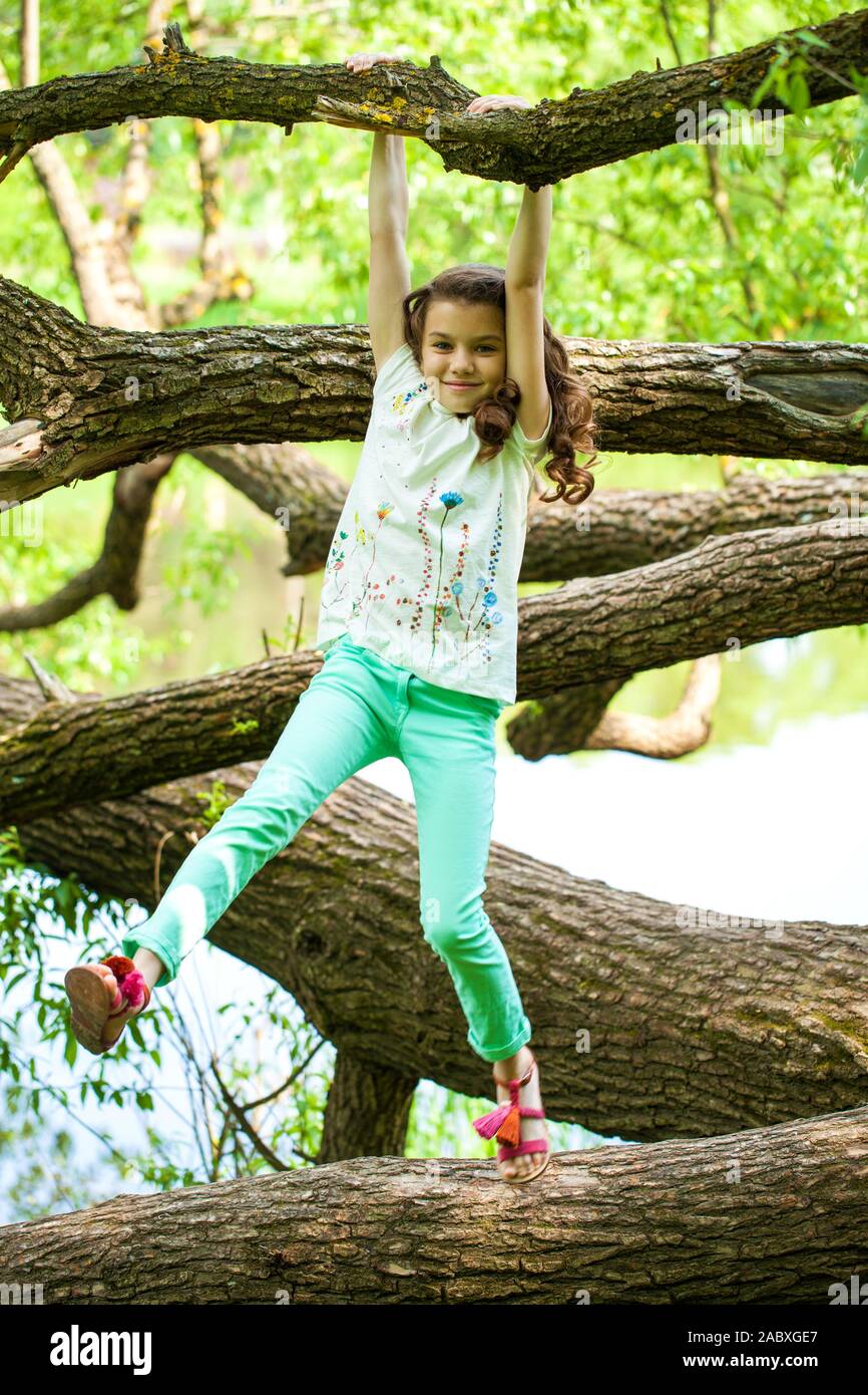 Happy Little Girl on tree trunk. Childhood, Summer forest Stock Photo ...