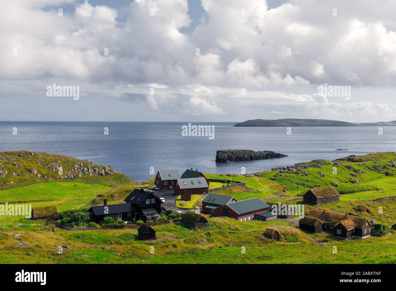 Summer view of small village with typical faroese turf-top houses on ...