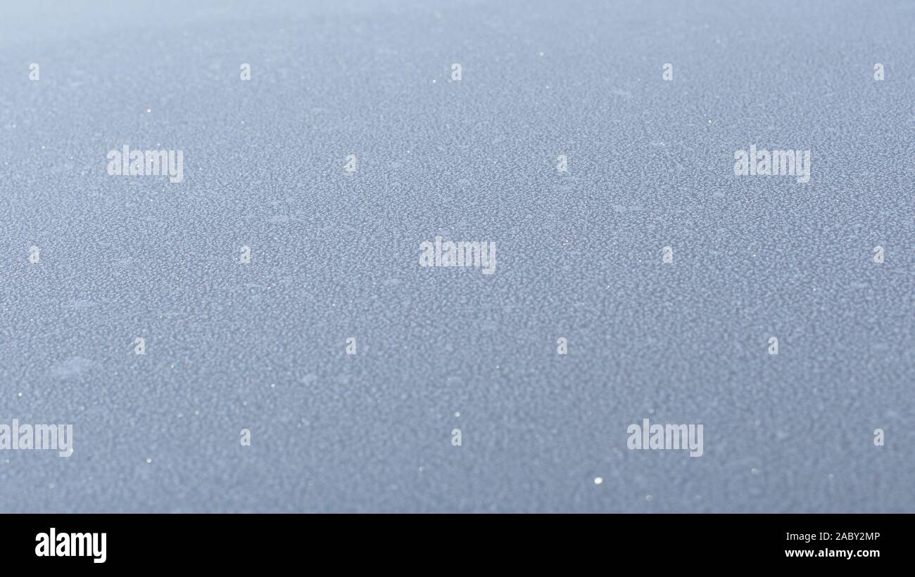 A thin layer of ice on the glass frost, the formation of snowflakes ...