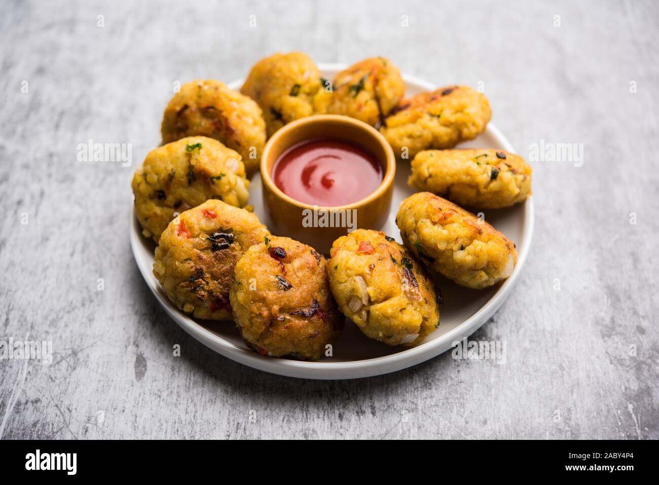 Veg Poha Cutlet or flattened Rice Patties served with tomato ketchup ...