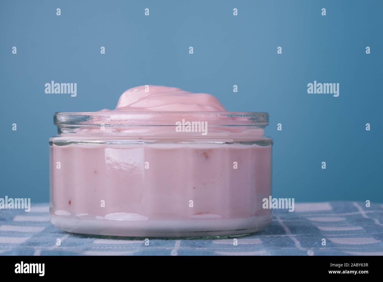 Pink strawberry yogurt in a clear glass bowl Stock Photo - Alamy