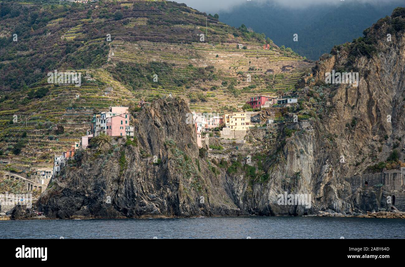 Italian village at the edge of a rocky cliff near the picturesque and ...
