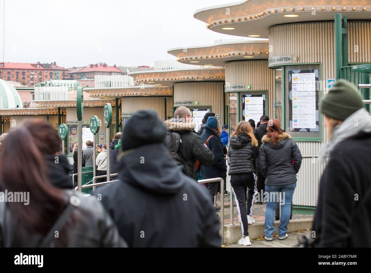 People stand in queues at the ticket office of the Scandinavia's ...