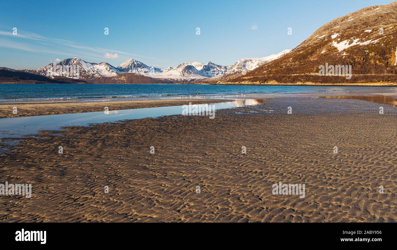 sunset over sandvika beach in Tromso region during a spring afternoon ...