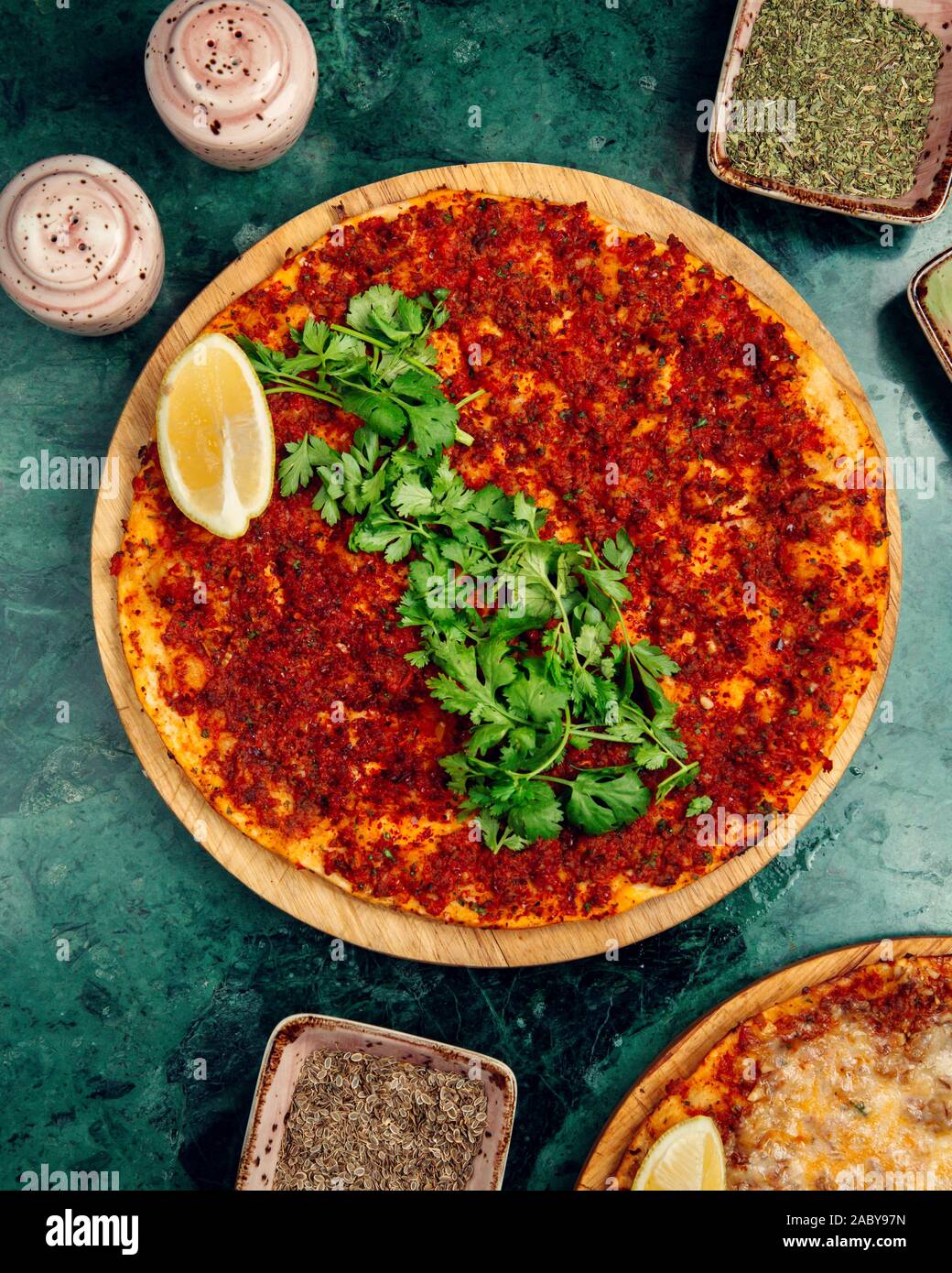 spicy turkish lahmajun topped with parsley and lemon Stock Photo - Alamy
