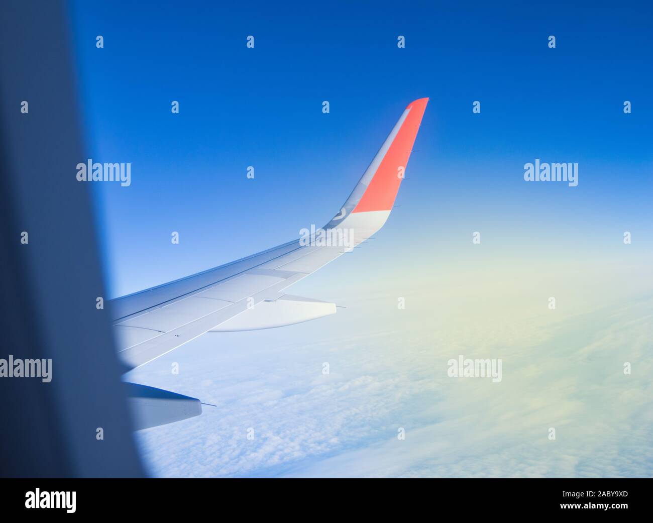 Looking through the plane window while flying on the wing with ...
