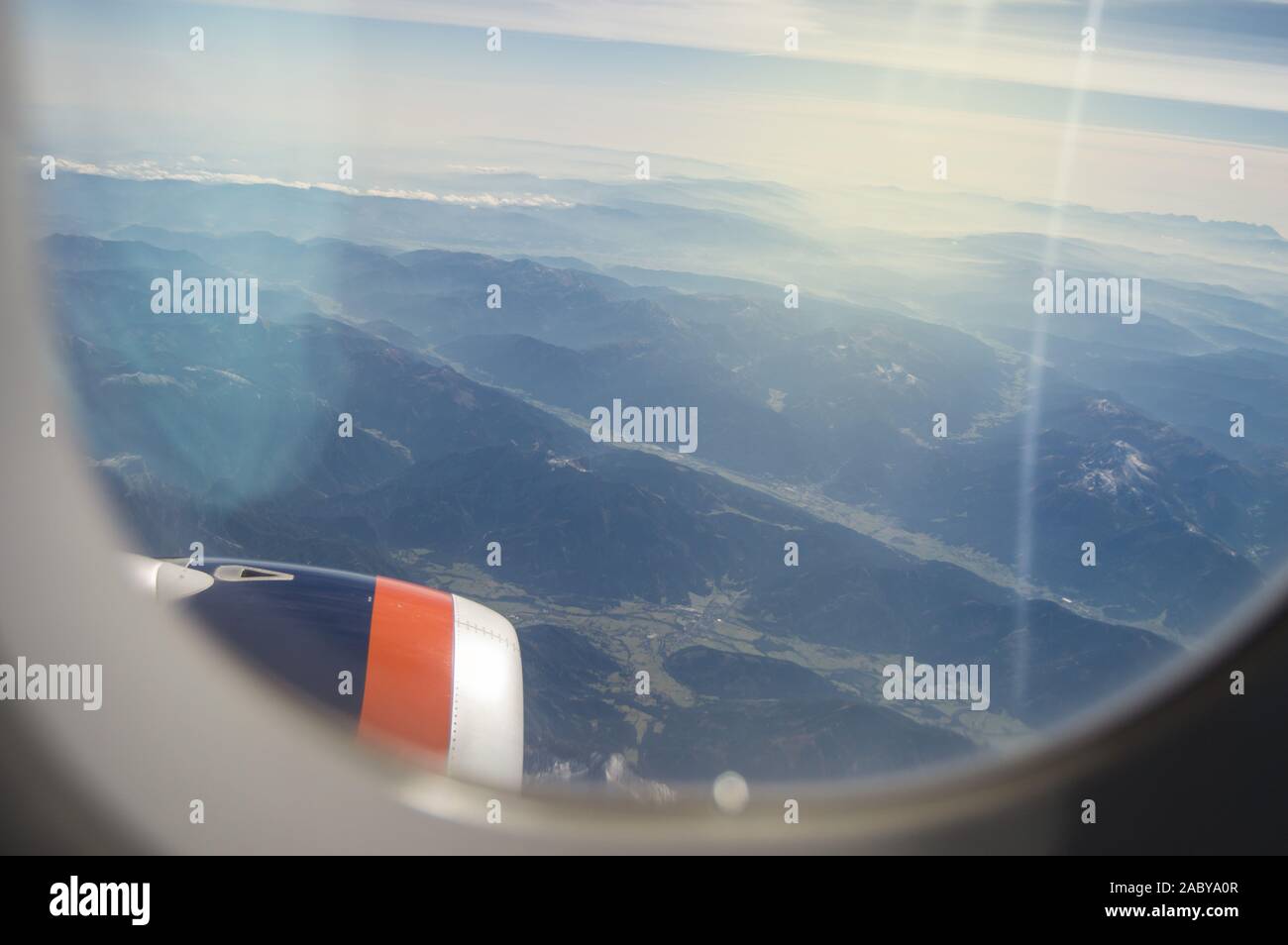 turbine of the aircraft is visible through the porthole against the sky ...