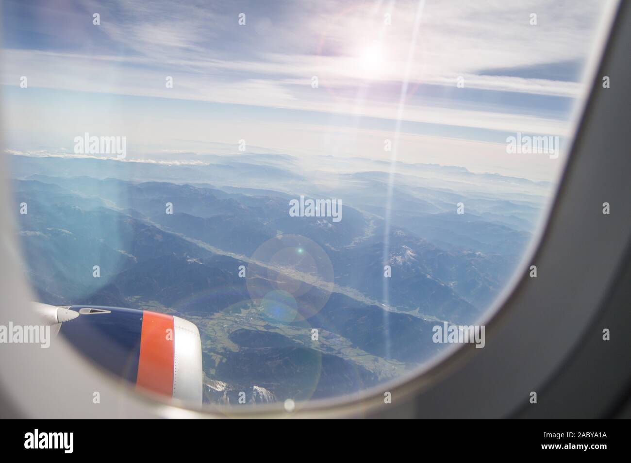turbine of the aircraft is visible through the porthole against the sky ...