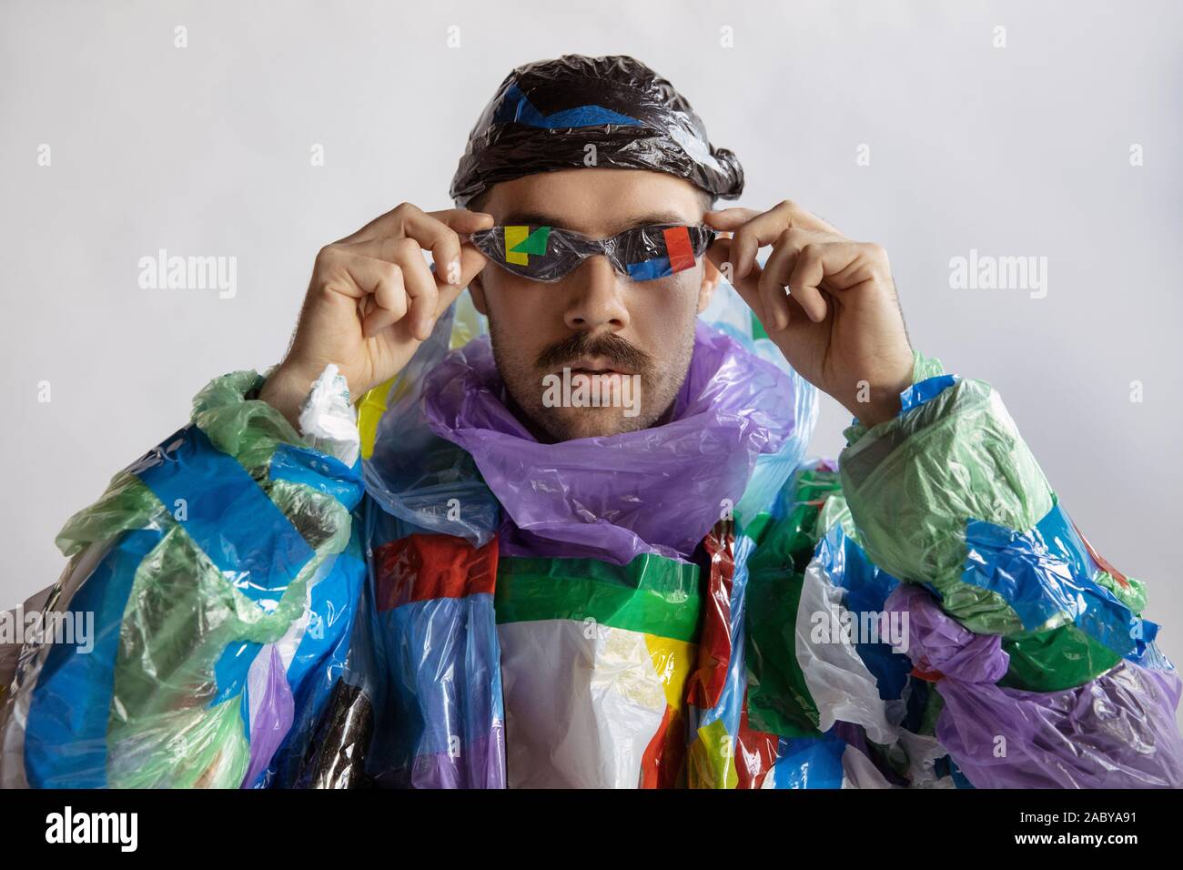 Close up of man wearing plastic on white background. Male model in ...