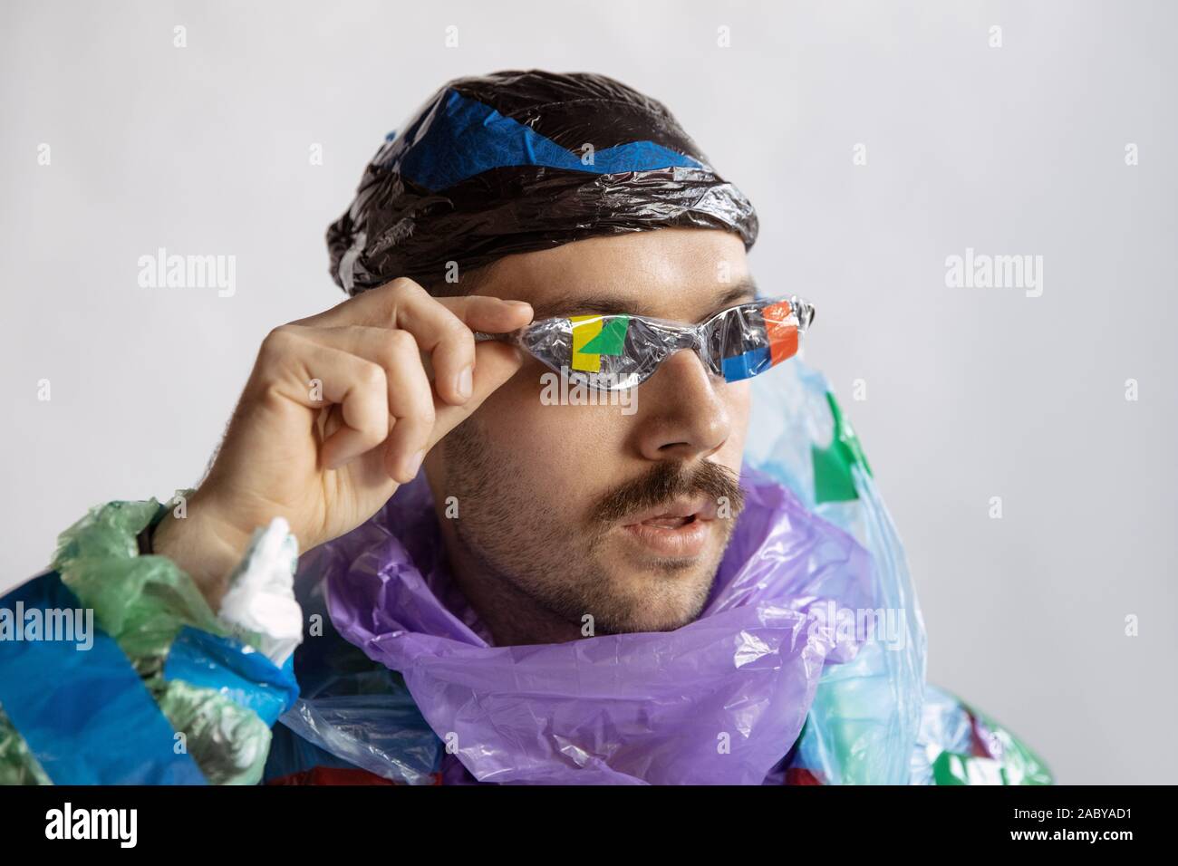 Close up of man wearing plastic on white background. Male model in ...