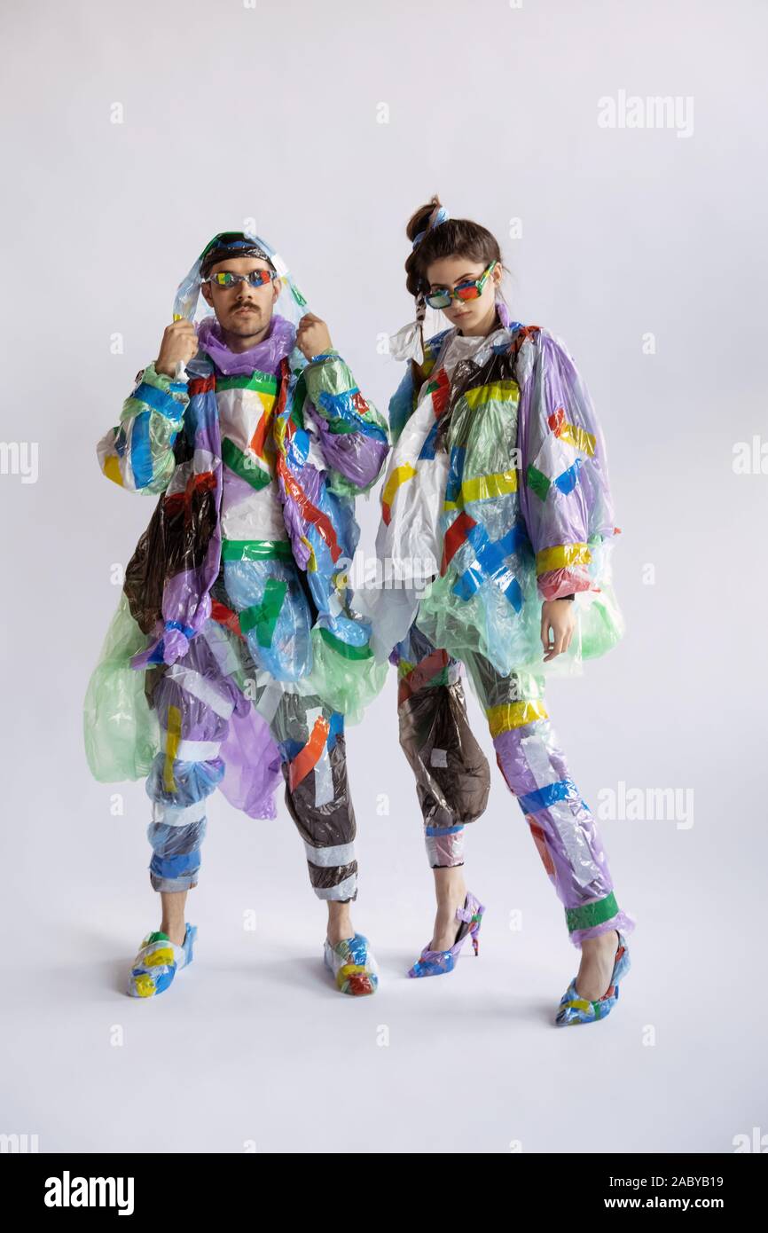 Woman and man wearing plastic on white background. Models in clothes ...