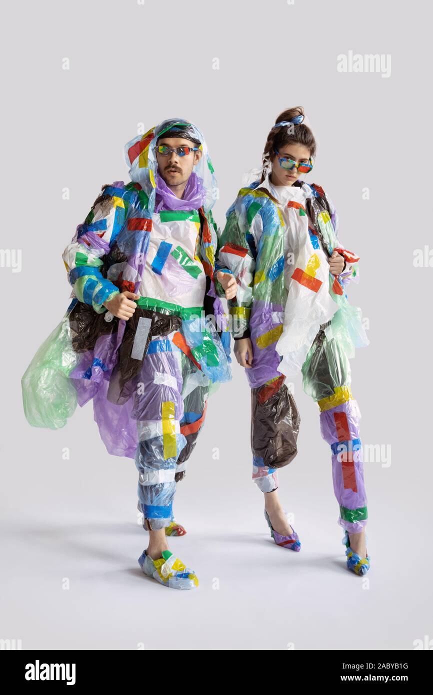 Woman and man wearing plastic on white background. Models in clothes ...