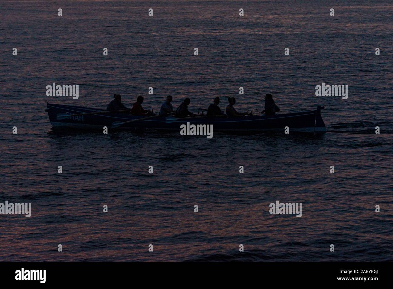 A Cornish pilot gig boat being rowed between the Isles of Scilly at ...