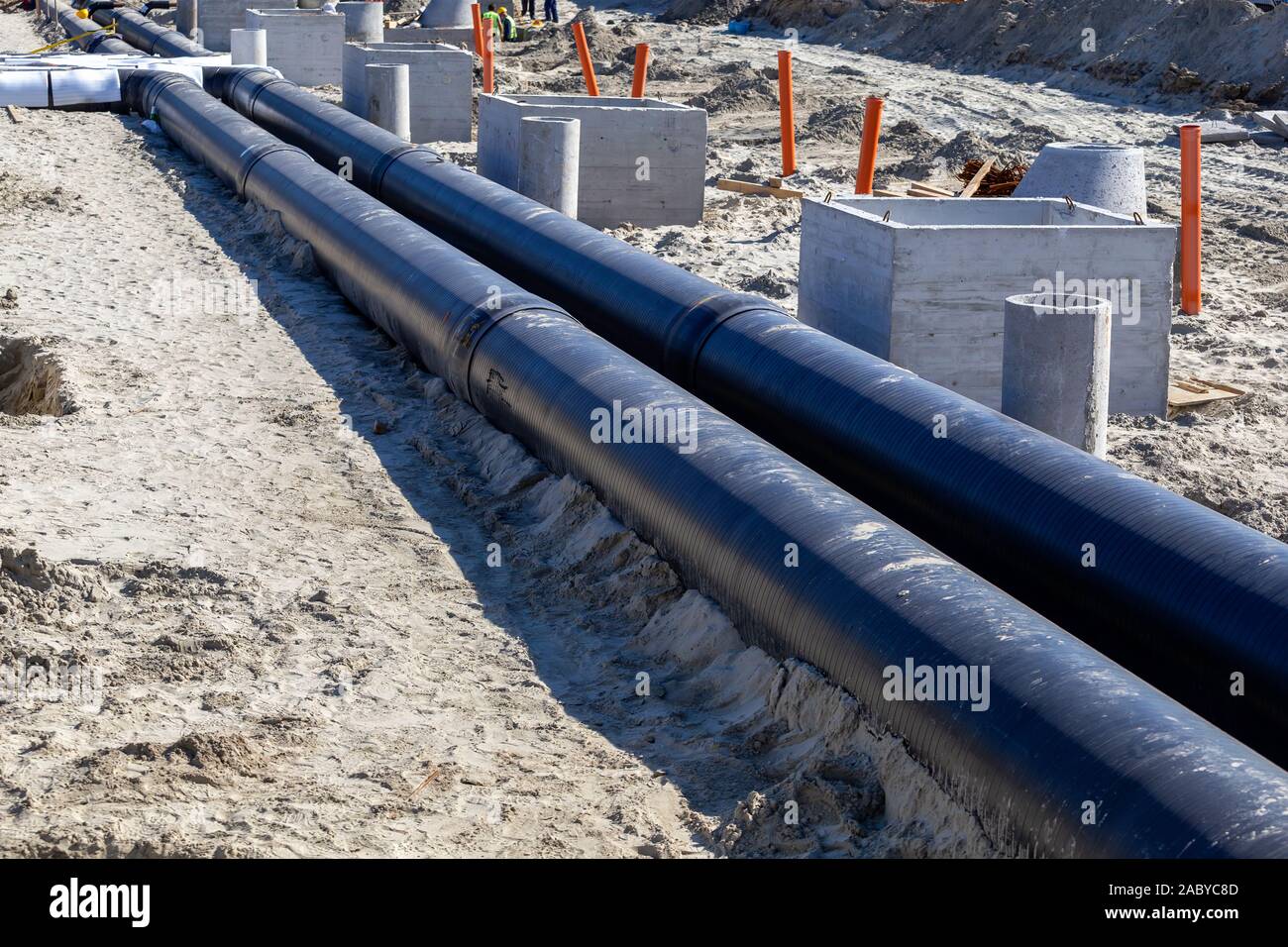 Black insulated pipes for underground district heating and manholes construction for draining ...