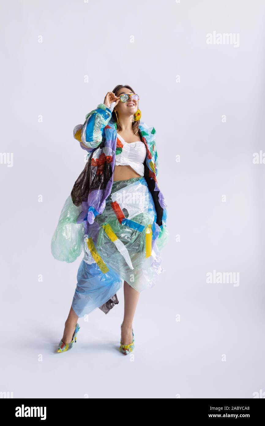 Woman wearing plastic on white background. Female model in clothes and ...