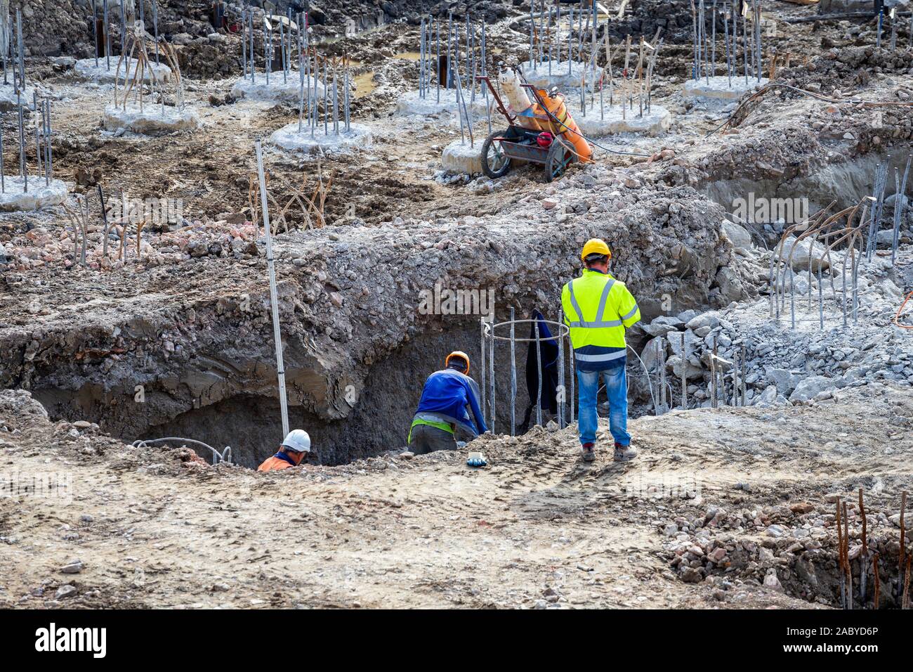 Construction workers and steel rebar reinforcement of building ...