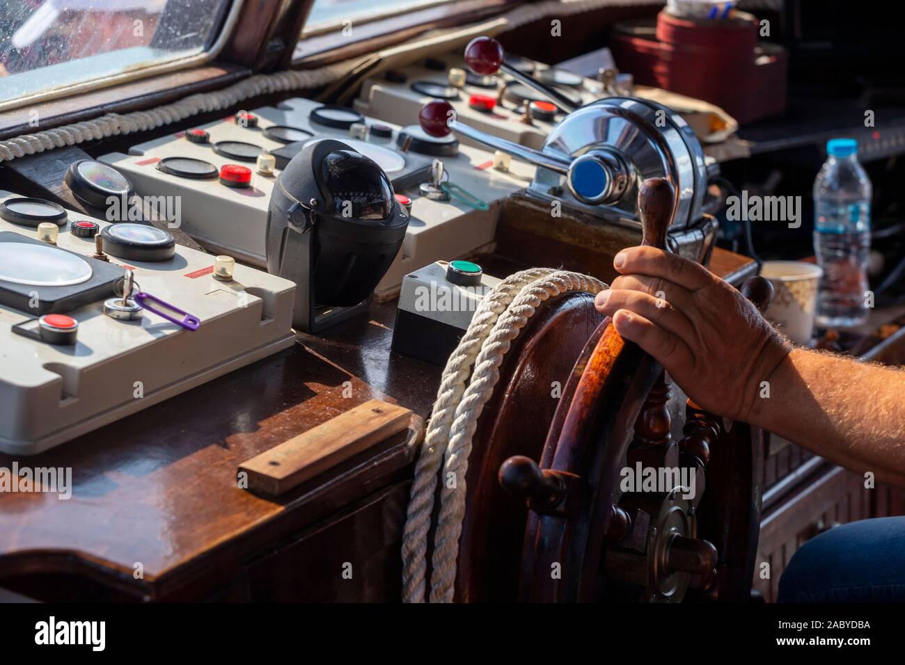 Control panel in tourist boat with hand on the steering wheel at ...